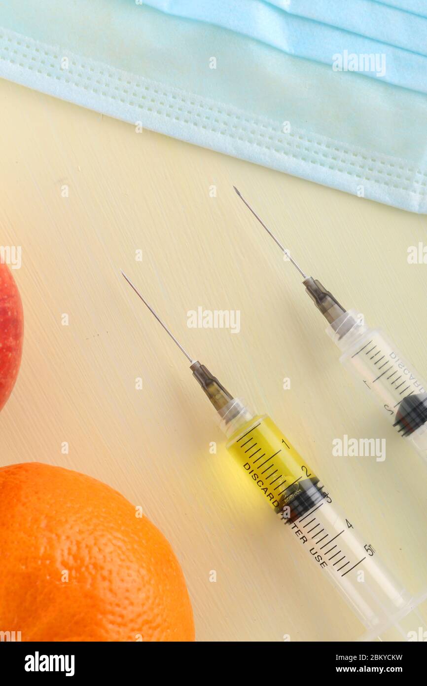 Chemical additives in food or genetically modified fruit concept. Red ...