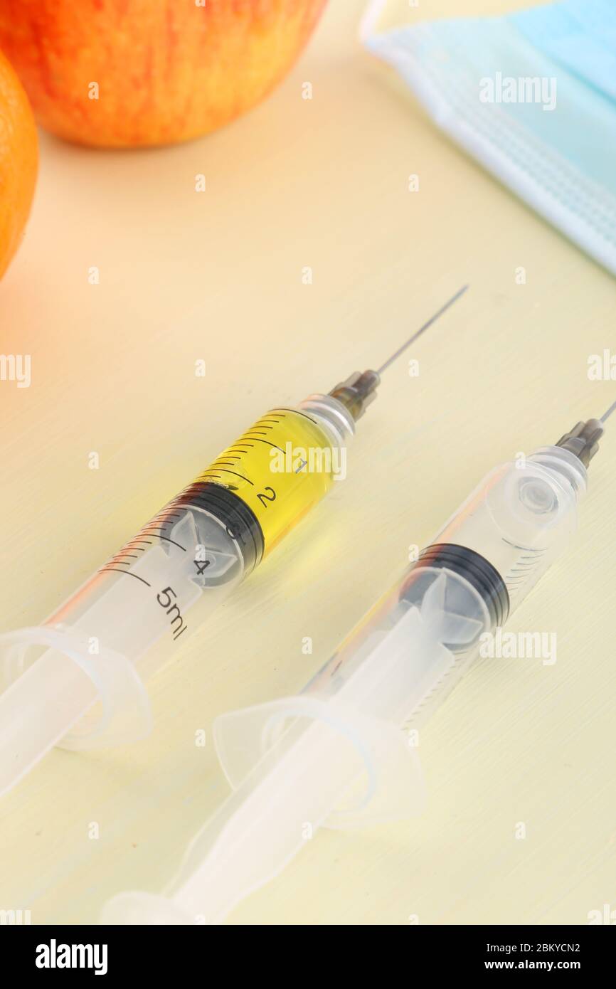 Chemical additives in food or genetically modified fruit concept. Red ...