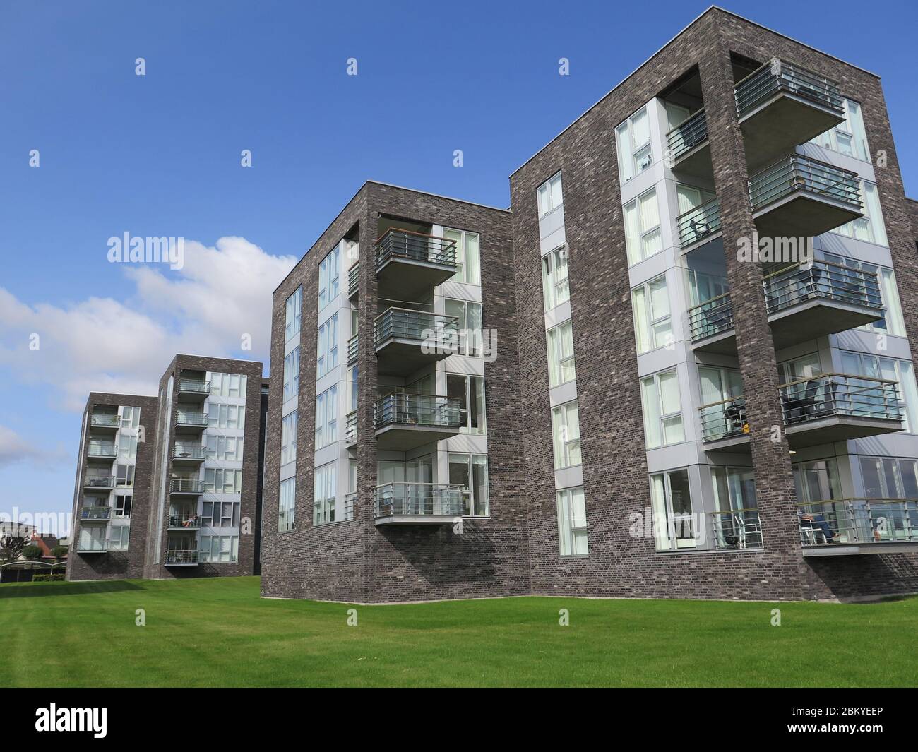Modern blocks of flats with grassy view on harbour front in Graasten ...