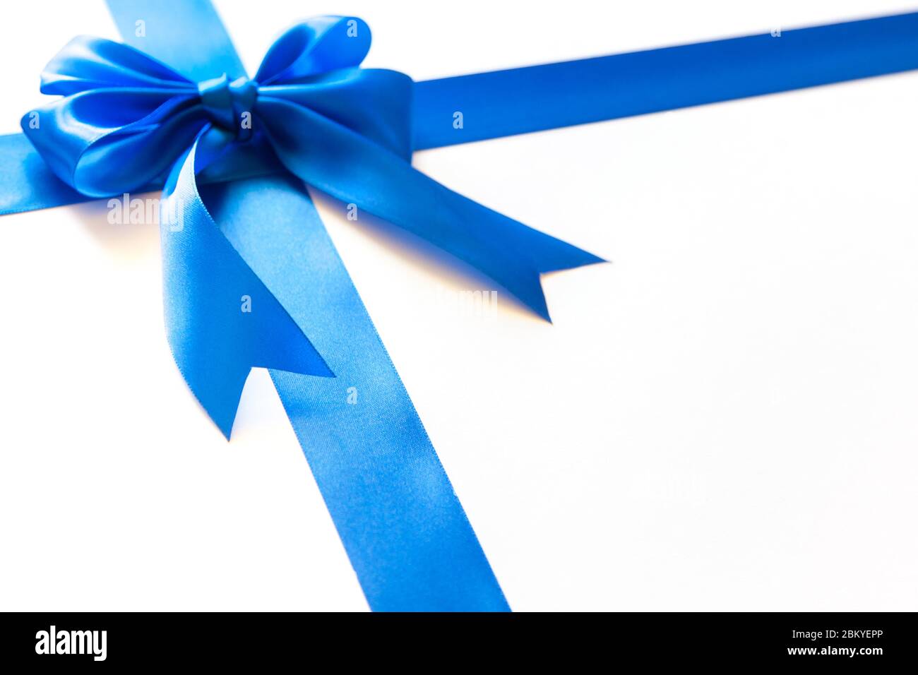 Blue ribbon with a bow as a gift on a white background Stock Photo - Alamy