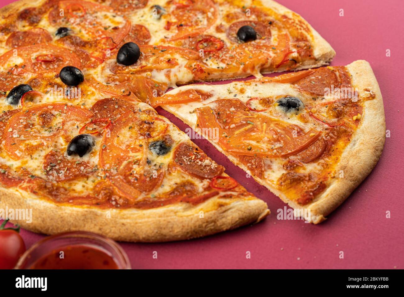 pizza close-up, isolated, against a colored background. whole pizza ...