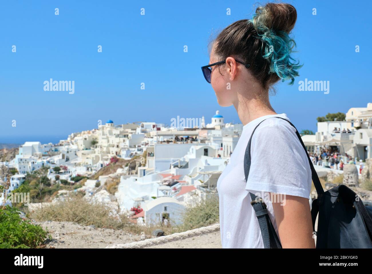 Teenager girl resting on Greek island Santorini, looking away Stock ...