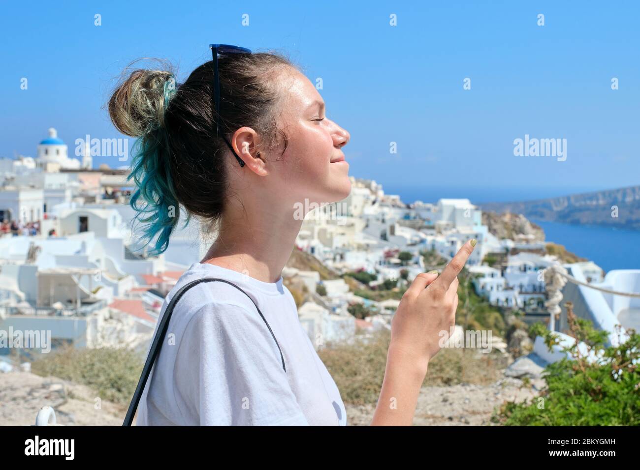 Teenager girl resting on Greek island Santorini, looking away Stock ...