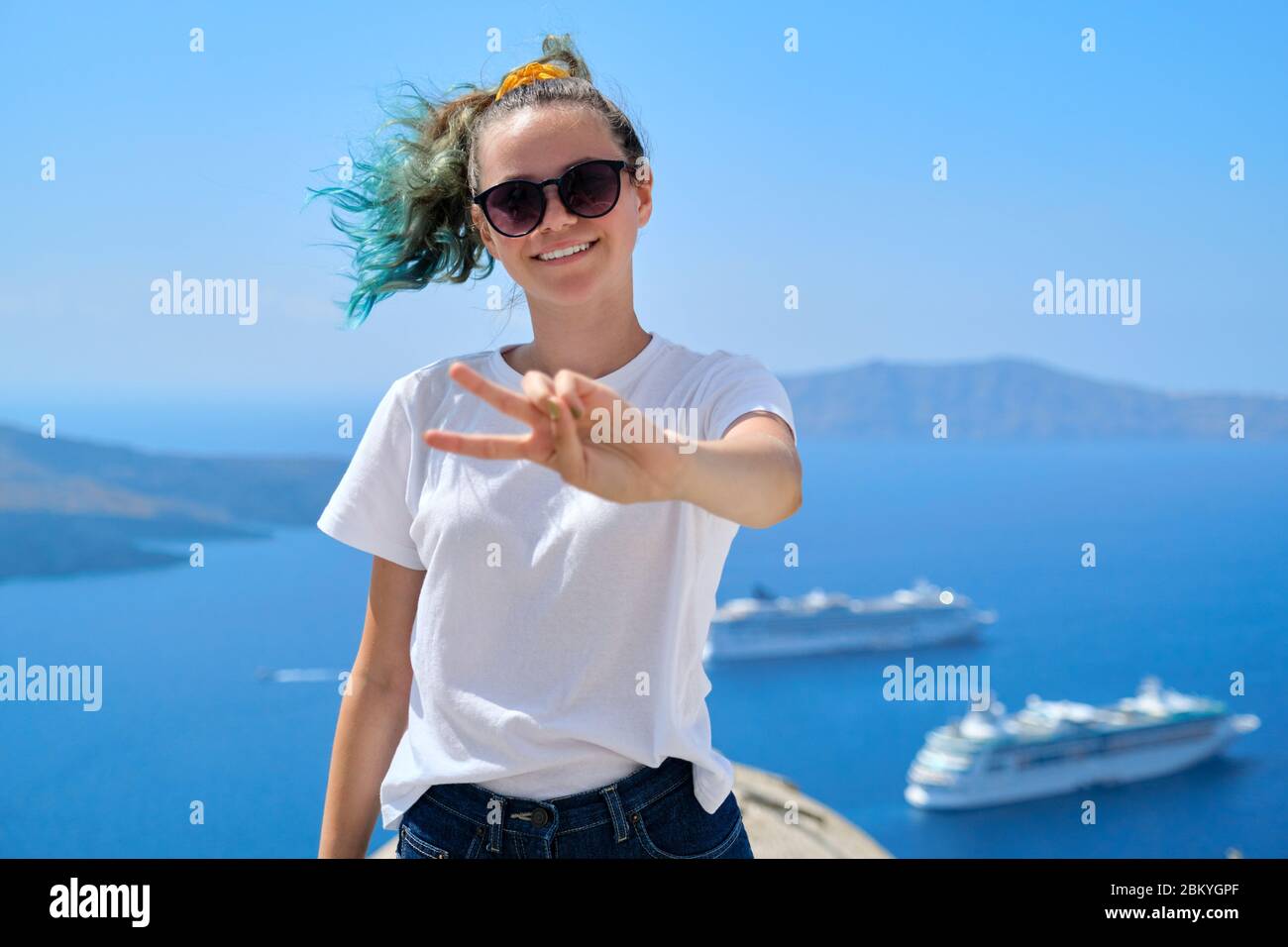 Teenager girl smiling, background sea landscape with white cruise ...