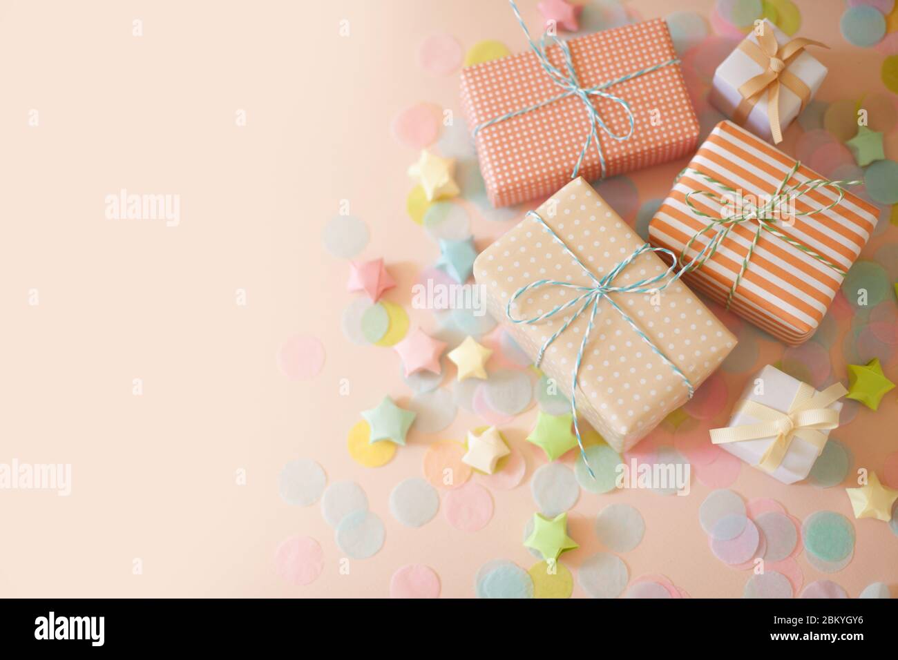 Gift boxes and pastel color confetti. Pink background Stock Photo - Alamy