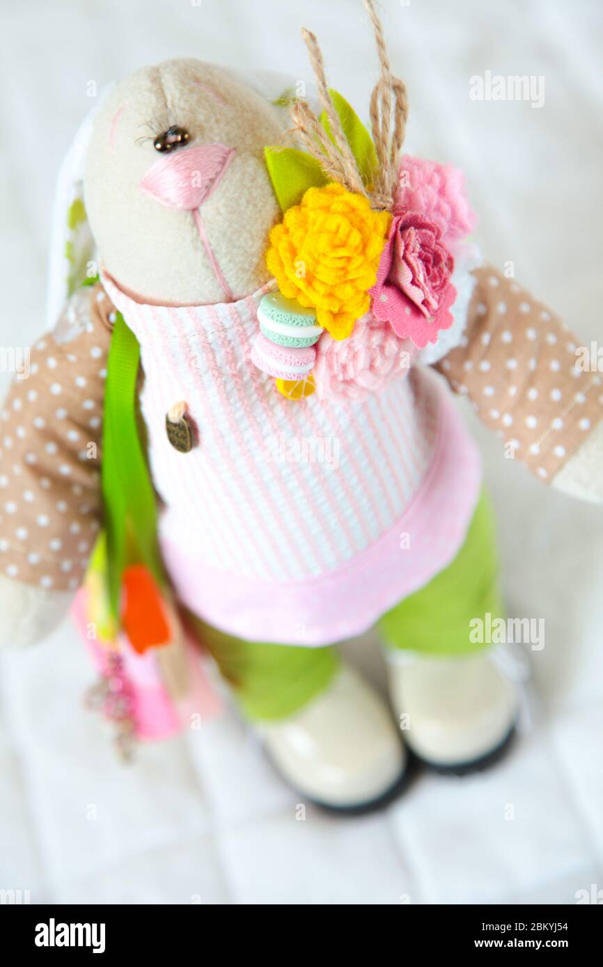 Handmade toy. Doll of textiles, fabrics and yarn. Rabbit with flower ...