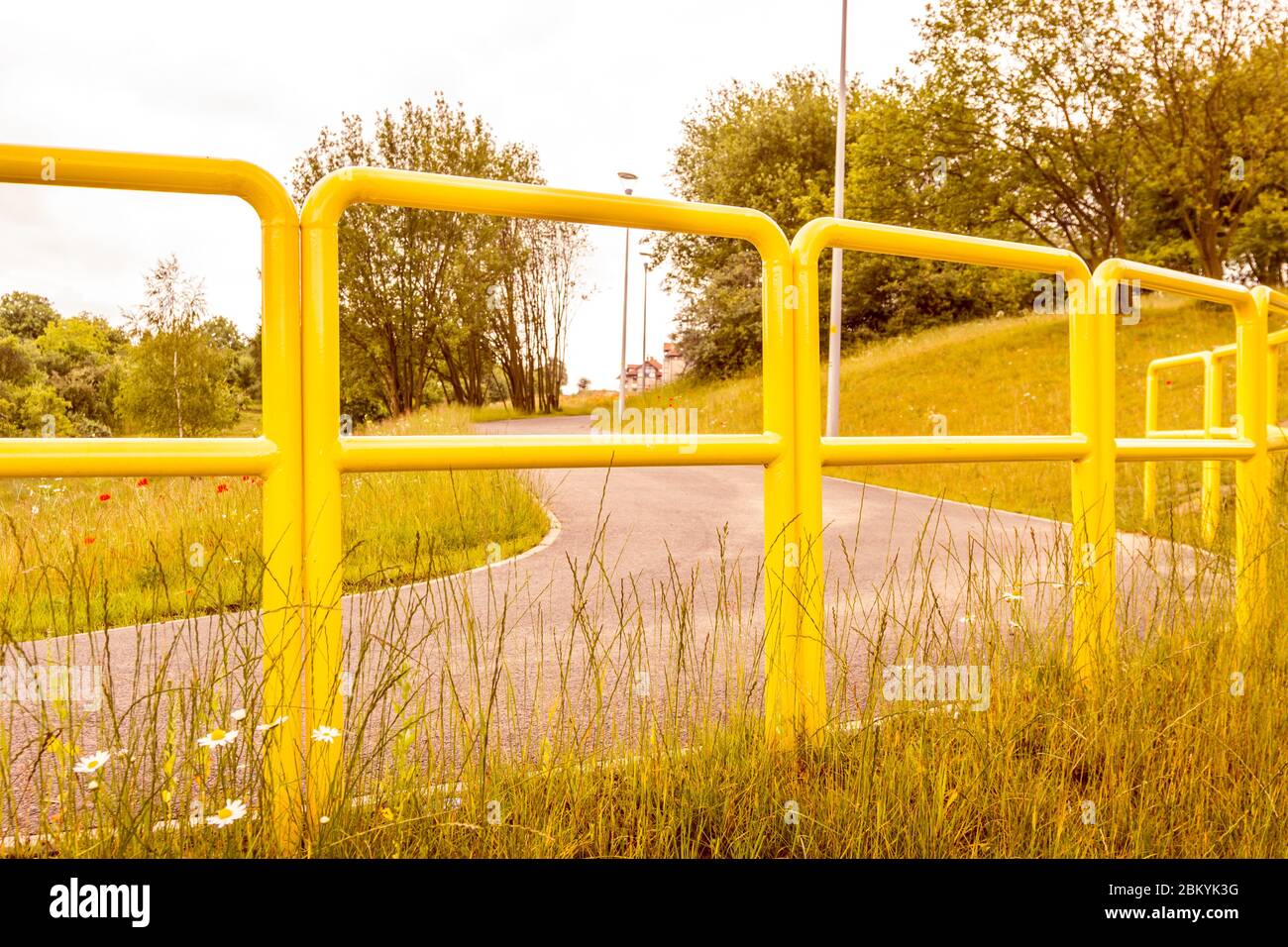 Yellow road fence barrier railing. Bike cycle lane path Stock Photo - Alamy
