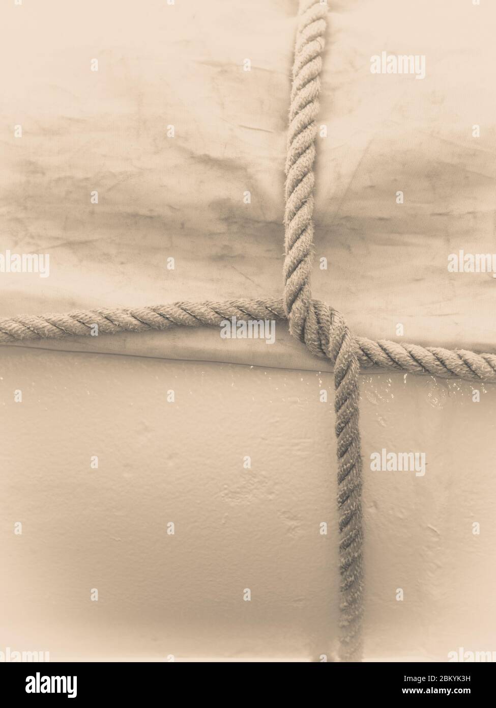 Old fashioned wicker rope wrapped around fabric material. Background ...