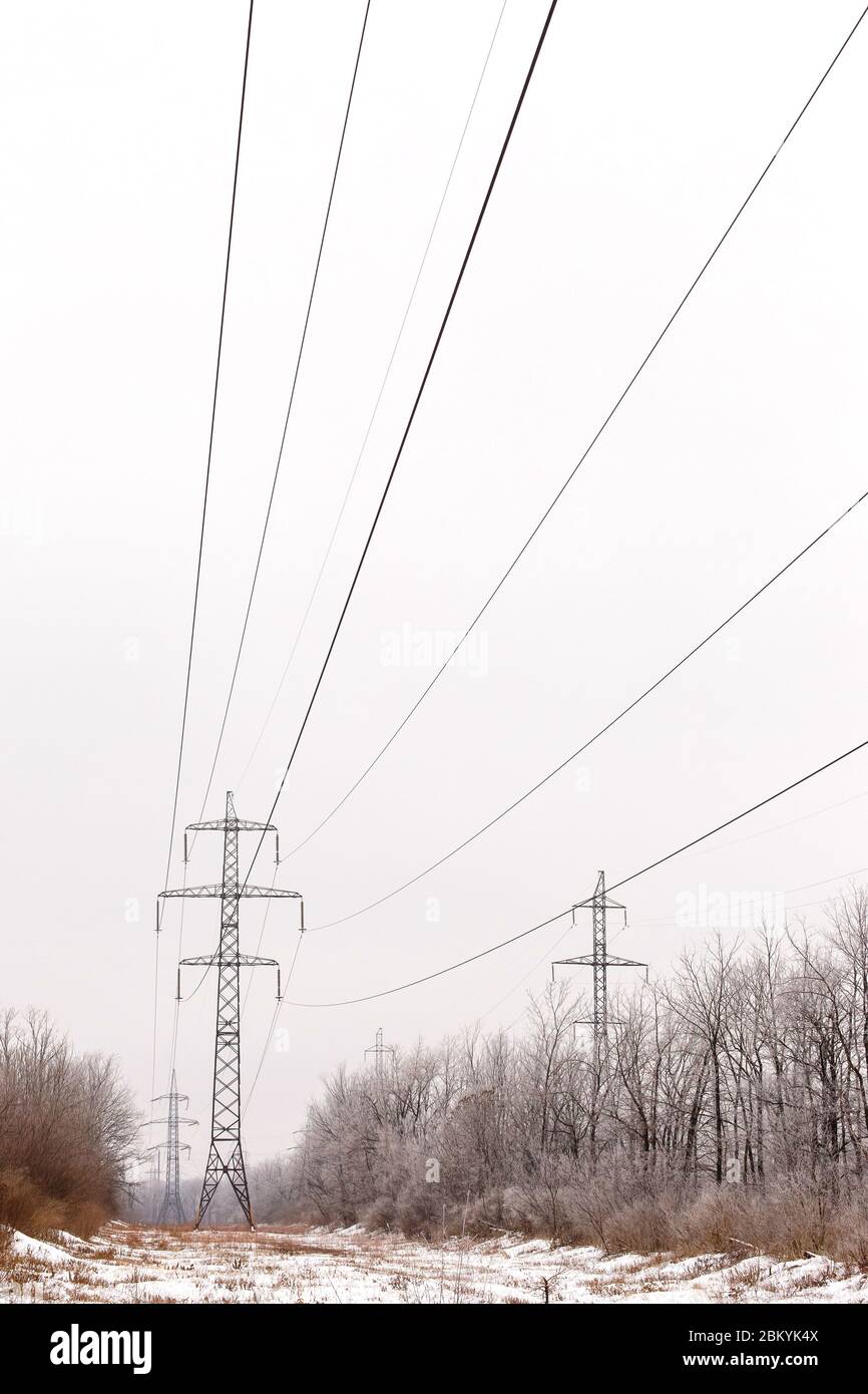 Supports high-voltage power lines in winter Stock Photo - Alamy