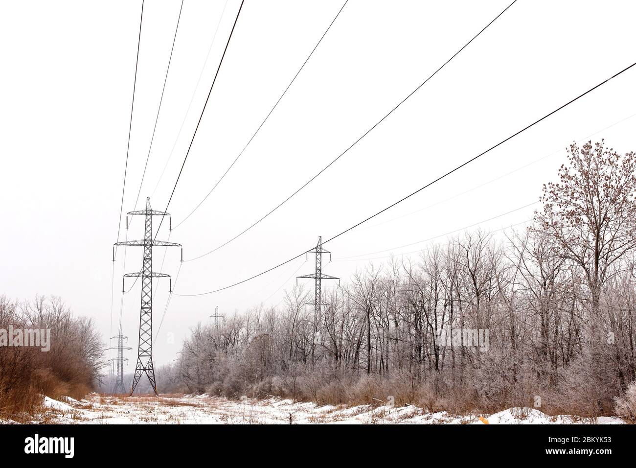 Supports high-voltage power lines in winter Stock Photo - Alamy