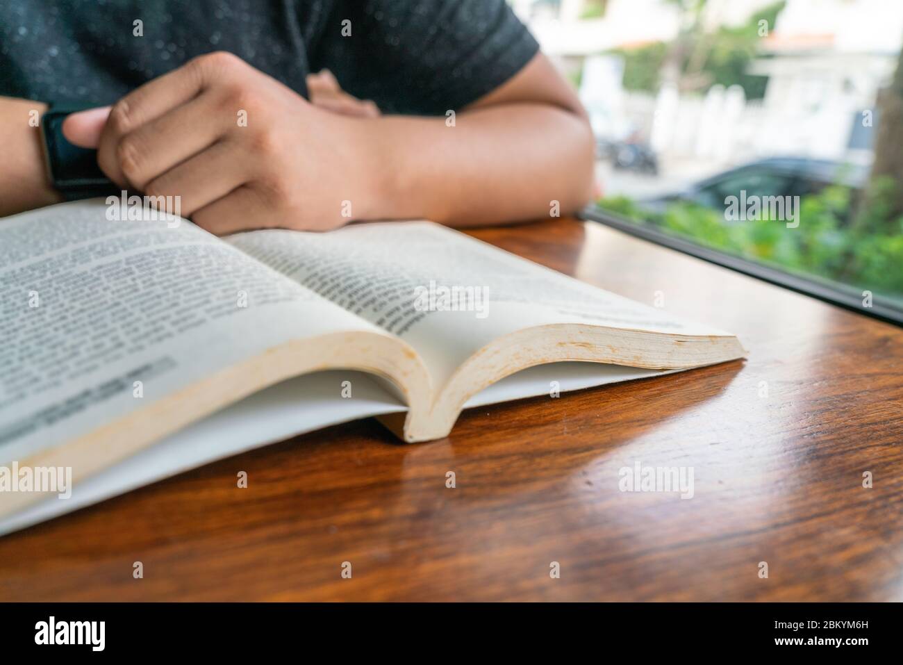 Close up photo of man reading book Stock Photo - Alamy