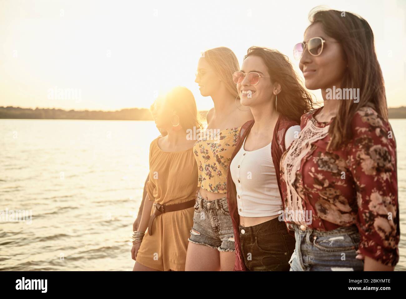 Four beautiful women on the beach Stock Photo - Alamy