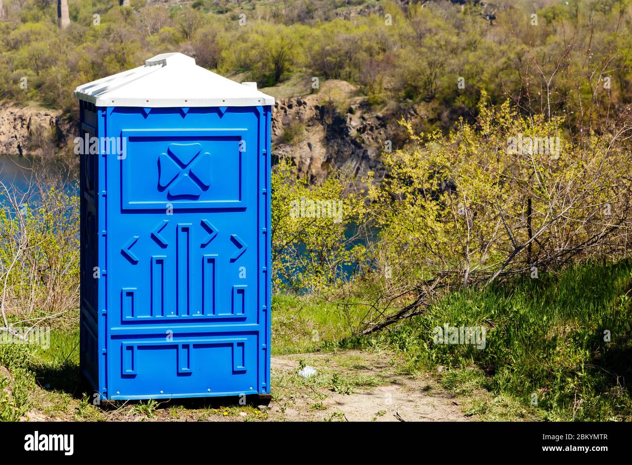 Blue Cabine Of Bio Toilet In a Mountain Park at sunny Summer Day Stock ...