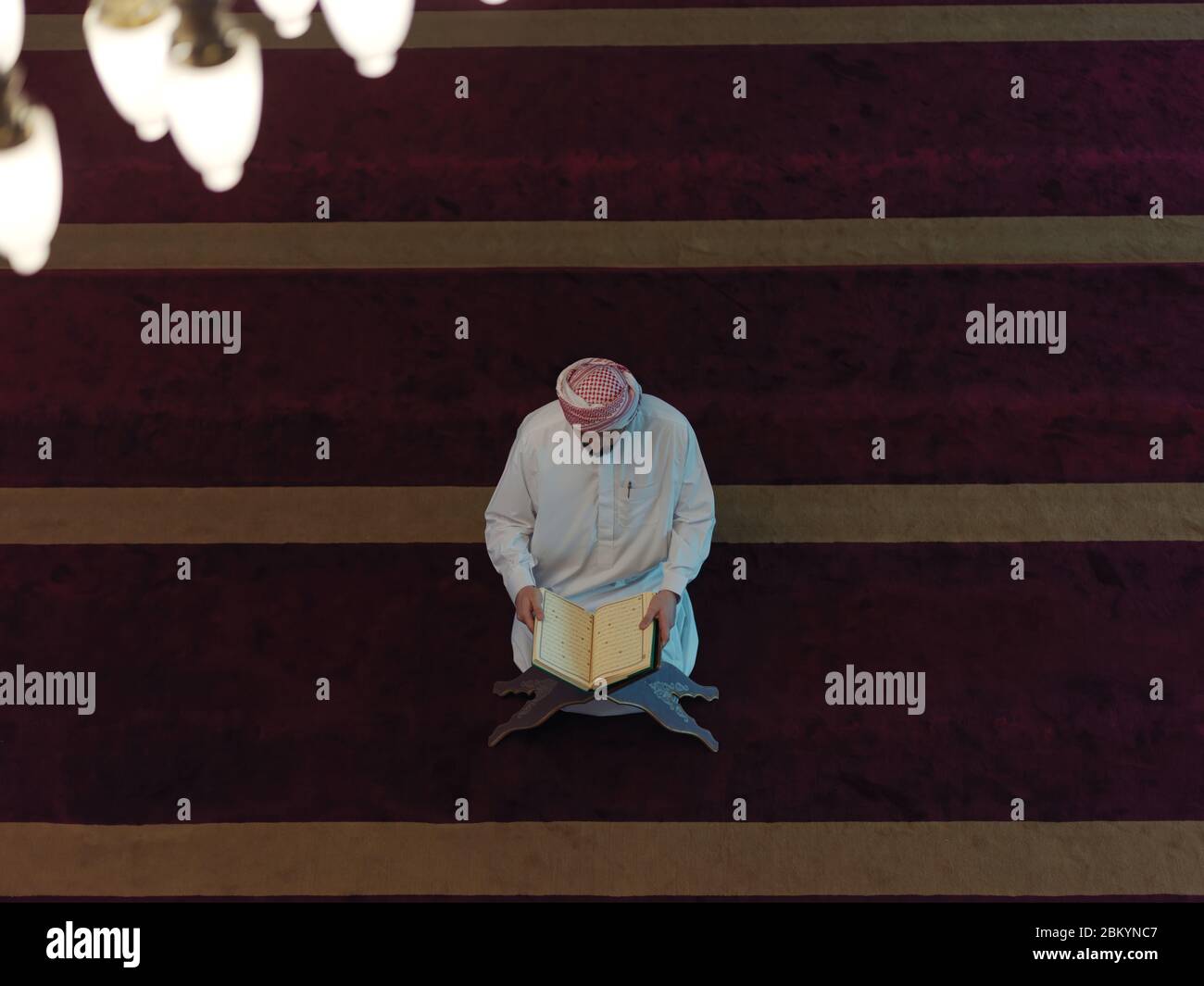 muslim man praying Allah alone inside the mosque and reading islamic ...