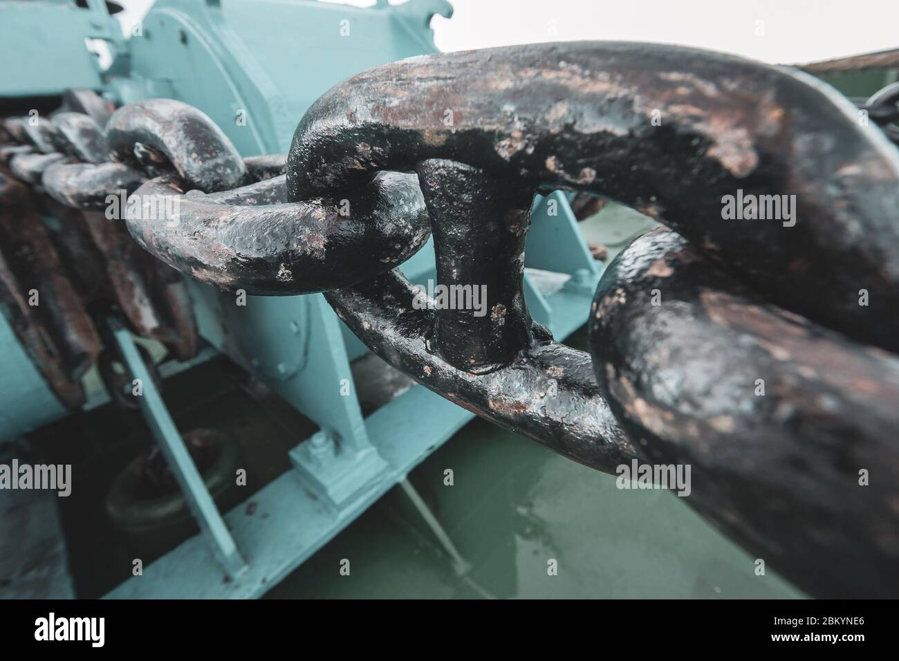 Marine anchor chain close-up and winding mechanism. Selective focus on ...