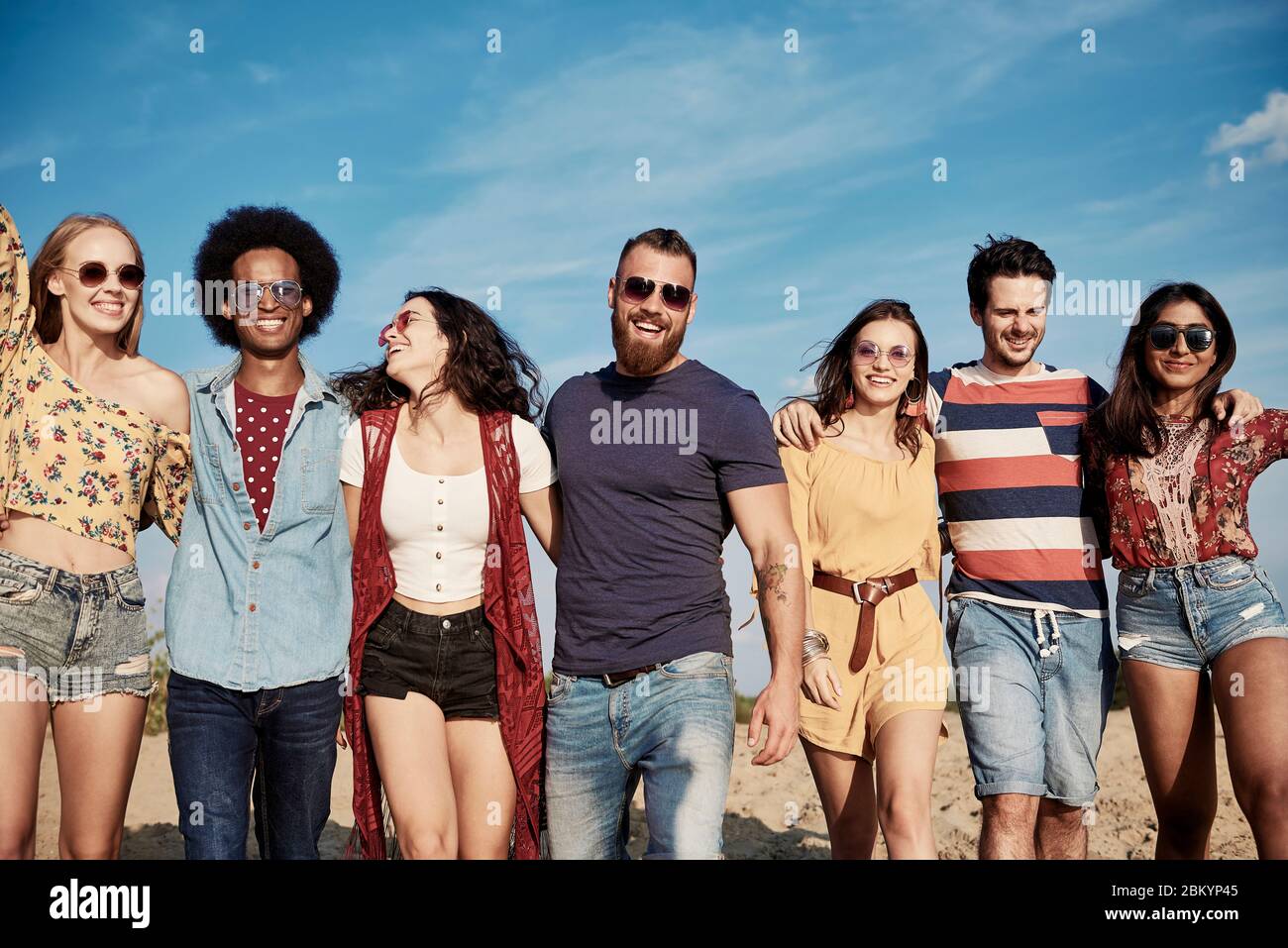 Young smiling people in a row on the fresh air Stock Photo - Alamy