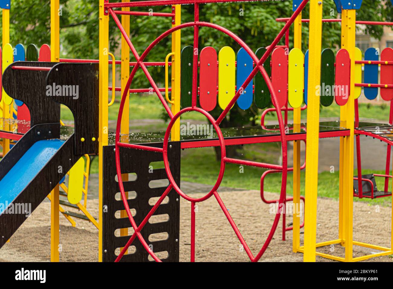 Empty swing at the playground in the rain. Children's swing in the park ...