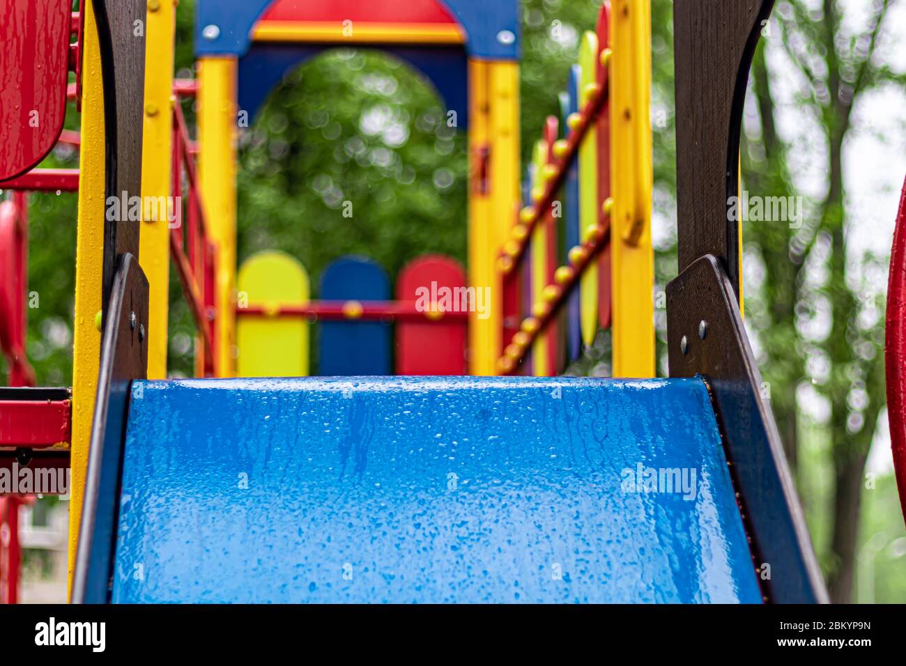 Empty swing at the playground in the rain. Children's swing in the park ...