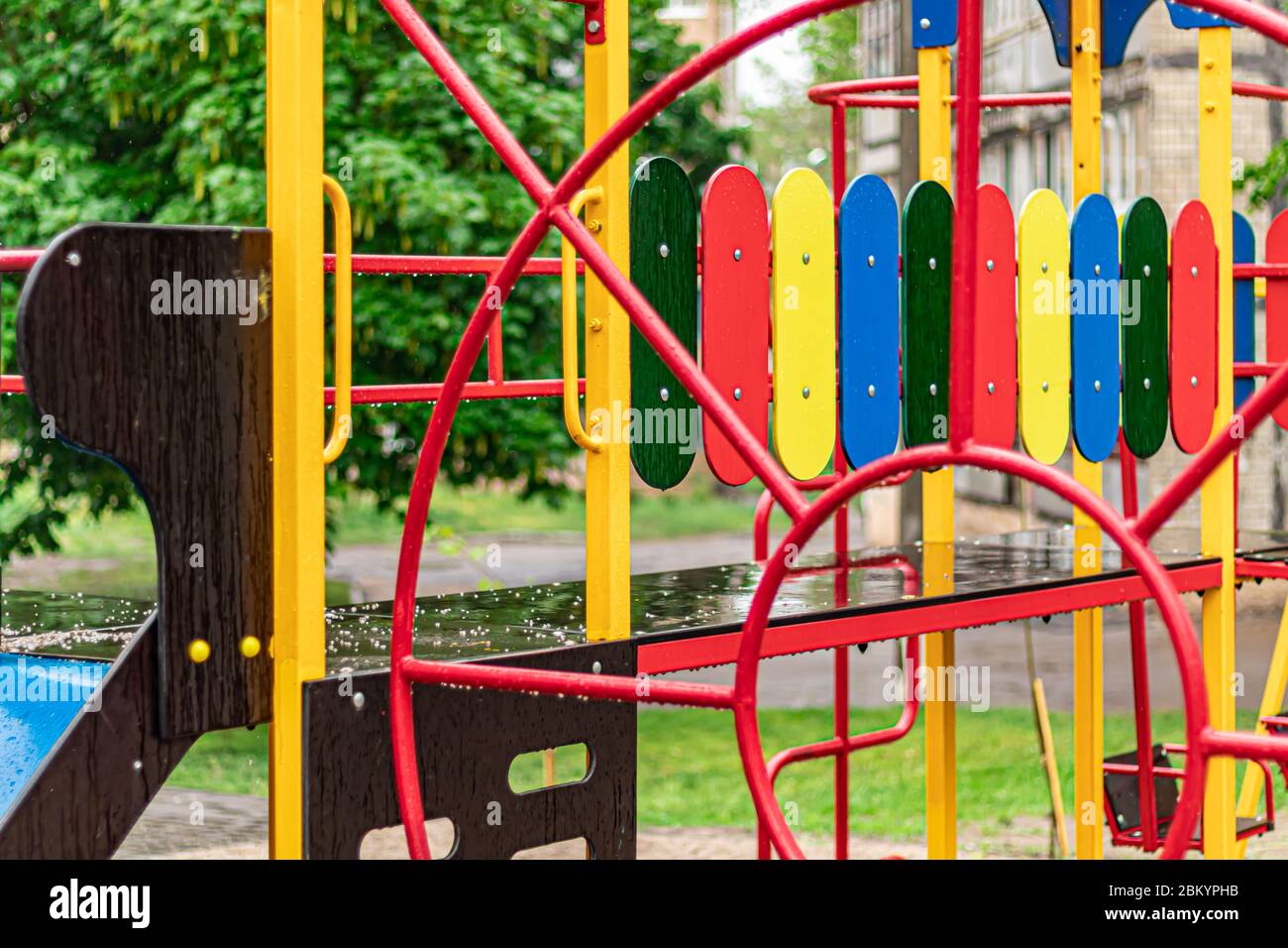 Empty swing at the playground in the rain. Children's swing in the park ...