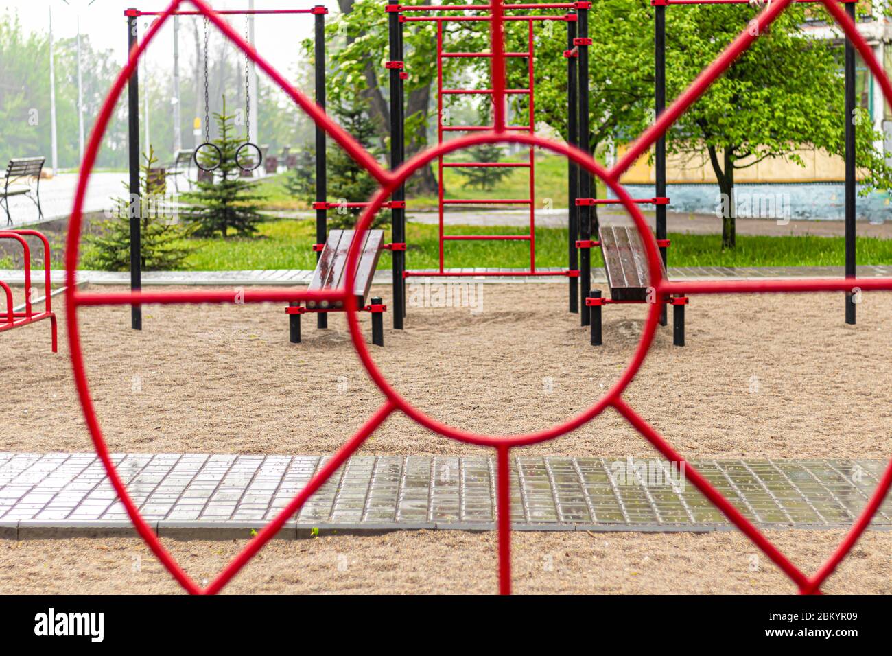 Empty swing at the playground in the rain. Children's swing in the park ...