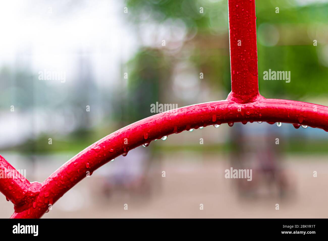 Empty swing at the playground in the rain. Children's swing in the park ...