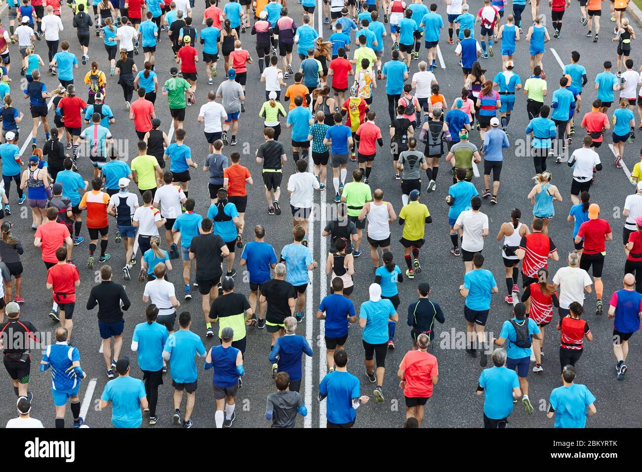 Urban marathon runners on the street. Healthy lifestyle. Athletes ...