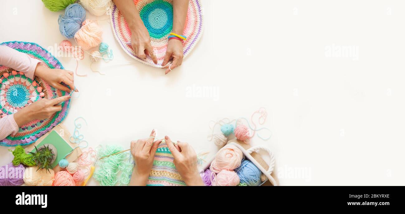 Master class on knitting. Women crochet and knit from colored yarn ...