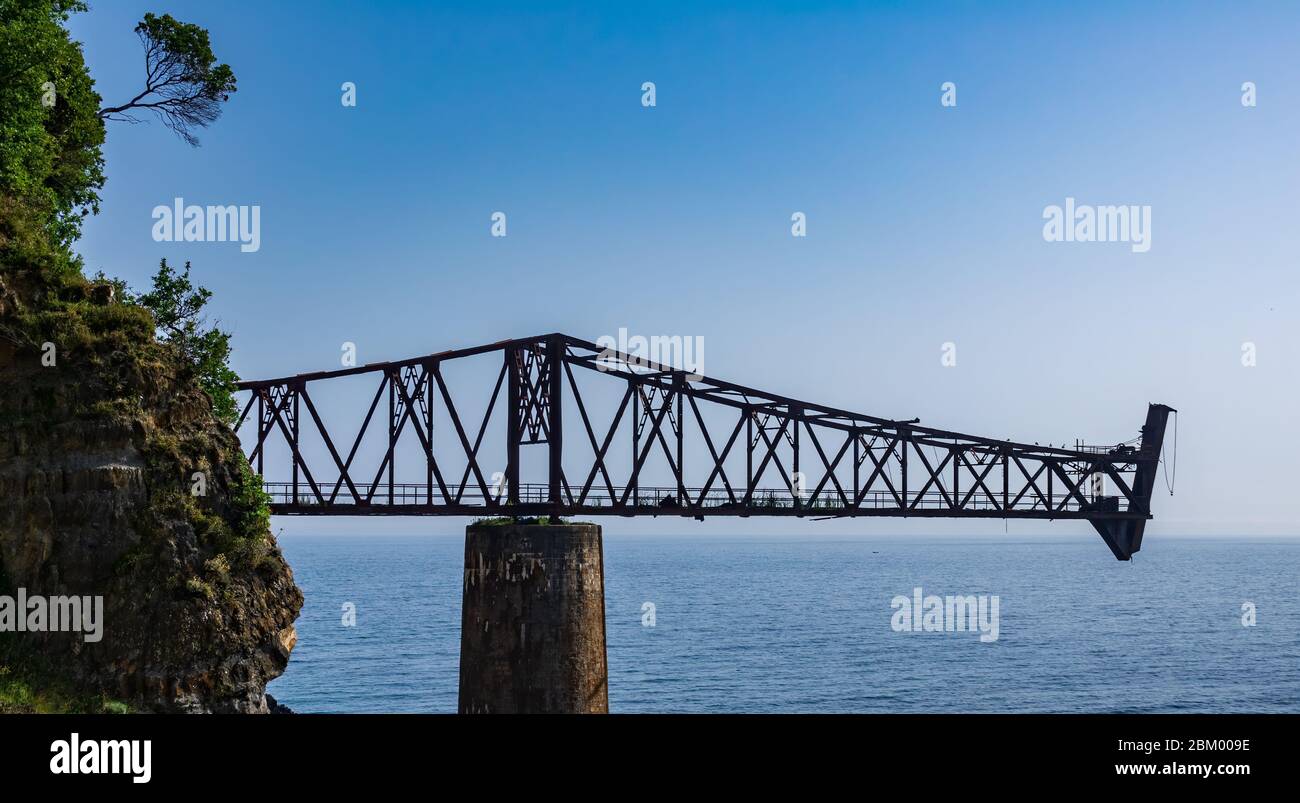 Old rusty abandoned iron loading bay in the ocean Stock Photo - Alamy