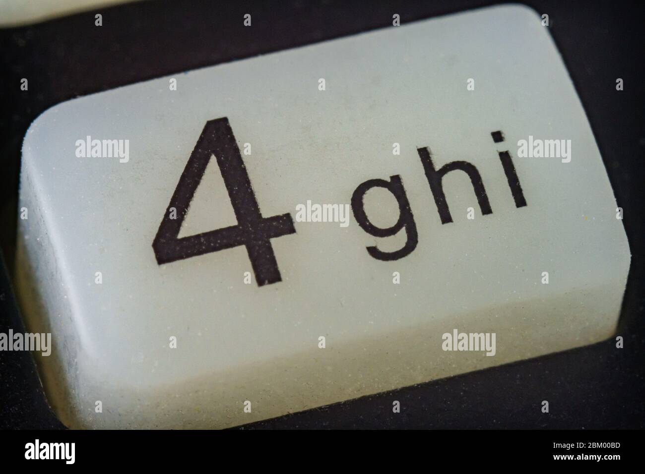 Extreme macro of number 4 button with letter Stock Photo - Alamy