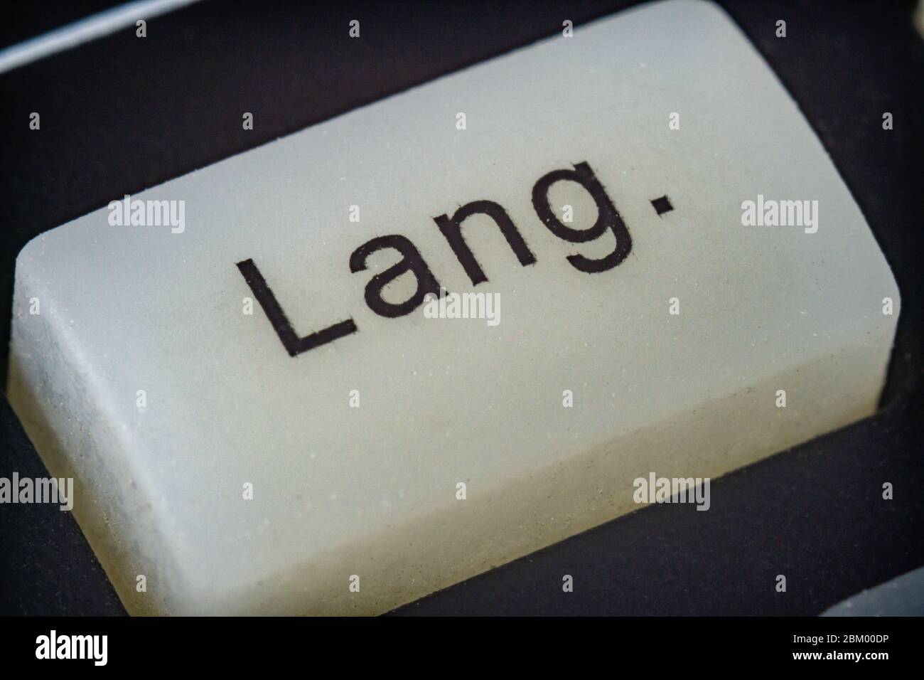 Extreme macro of a language button on a TV remote Stock Photo - Alamy