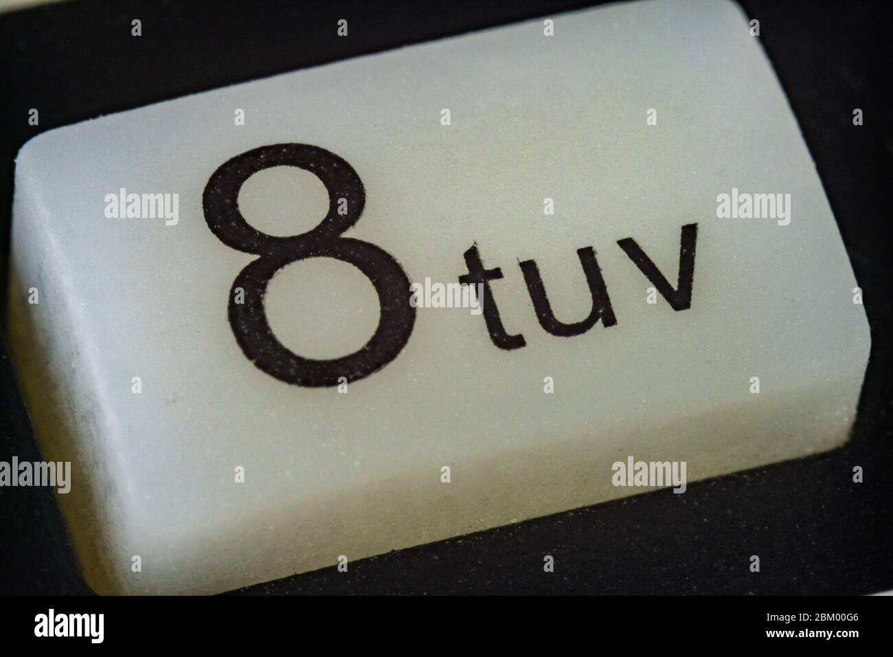 Extreme macro of number 8 button with letters Stock Photo - Alamy