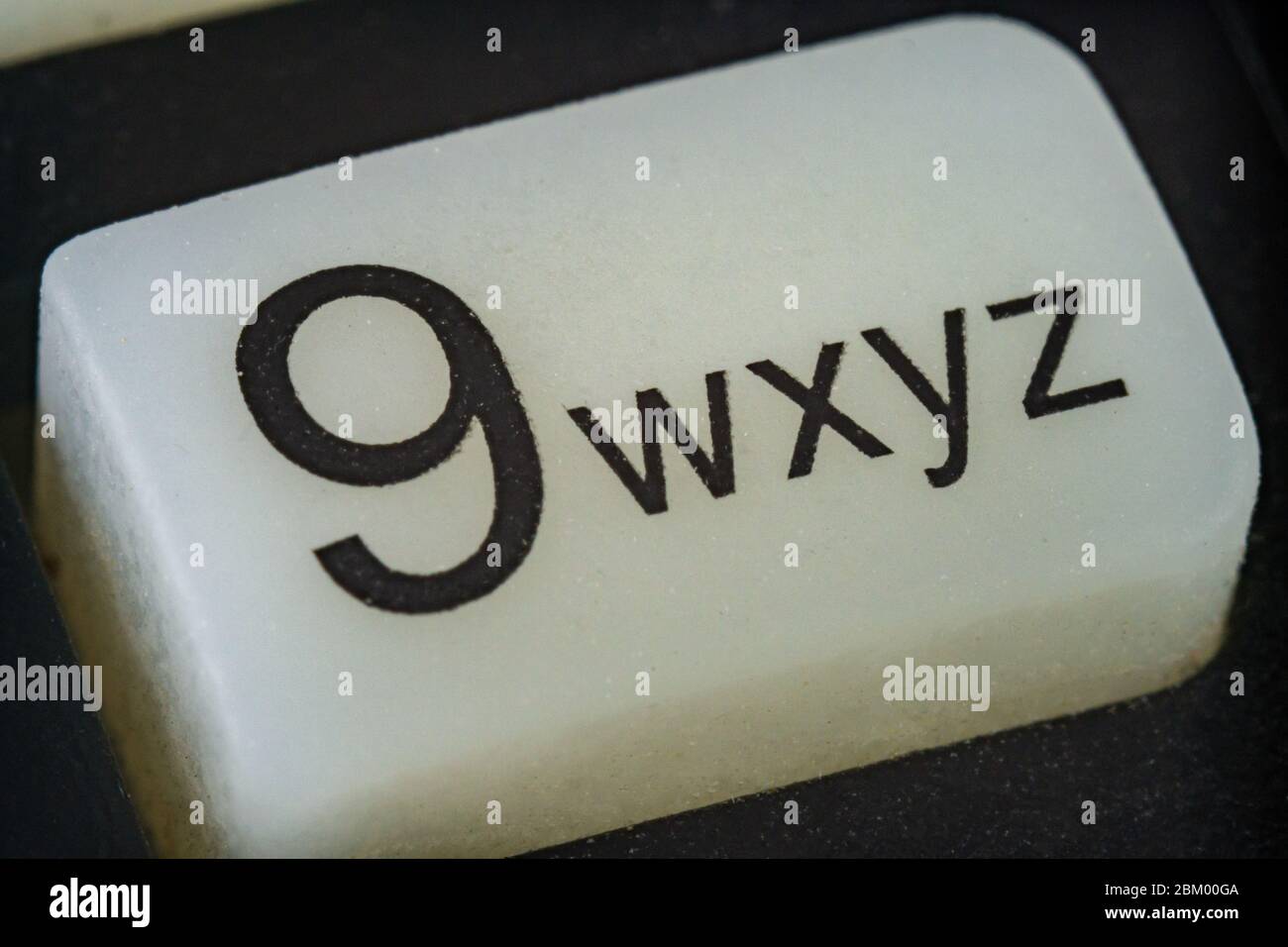 Extreme macro of number 9 button with letters Stock Photo - Alamy