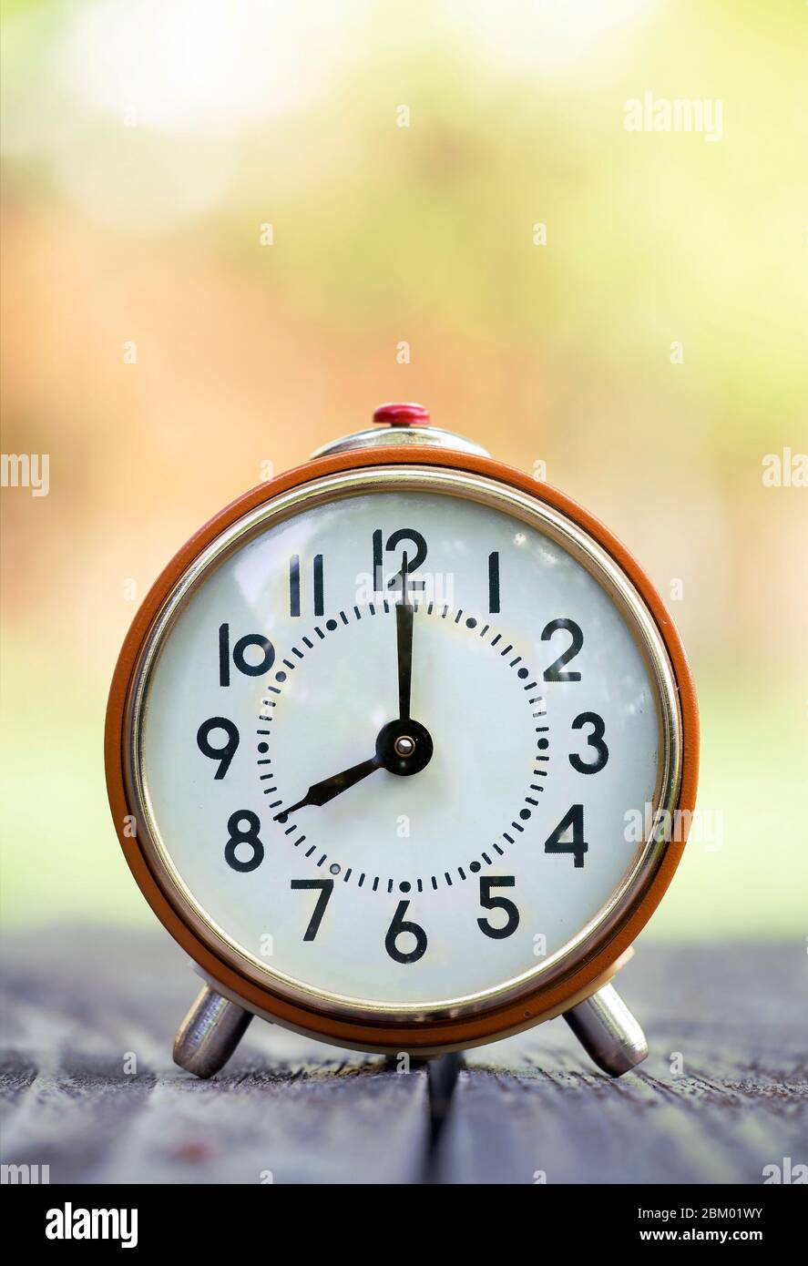 Save time concept - retro orange alarm clock close-up, vertical Stock ...