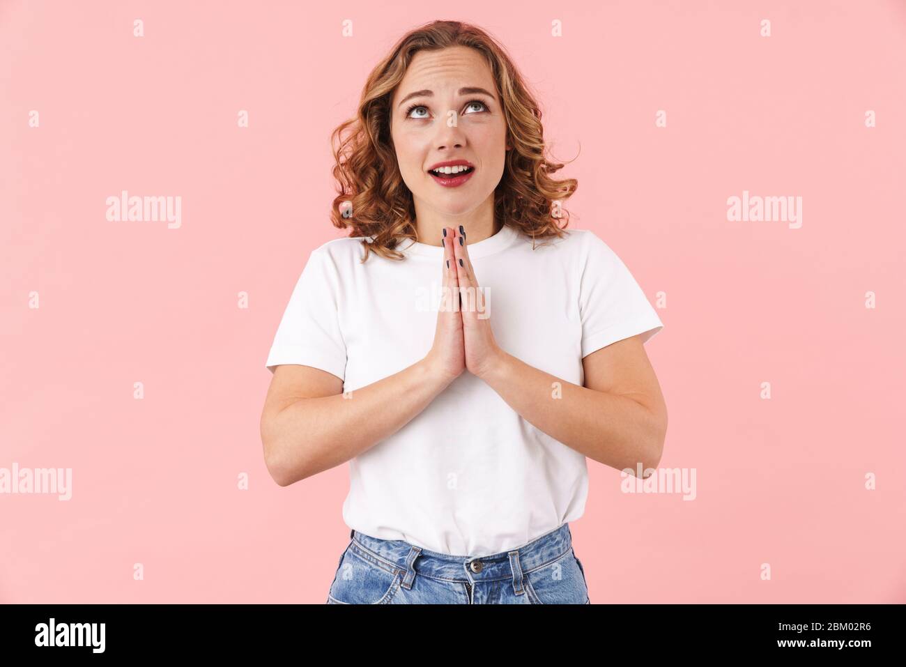 Photo of a cute young pretty woman posing isolated over pink wall ...