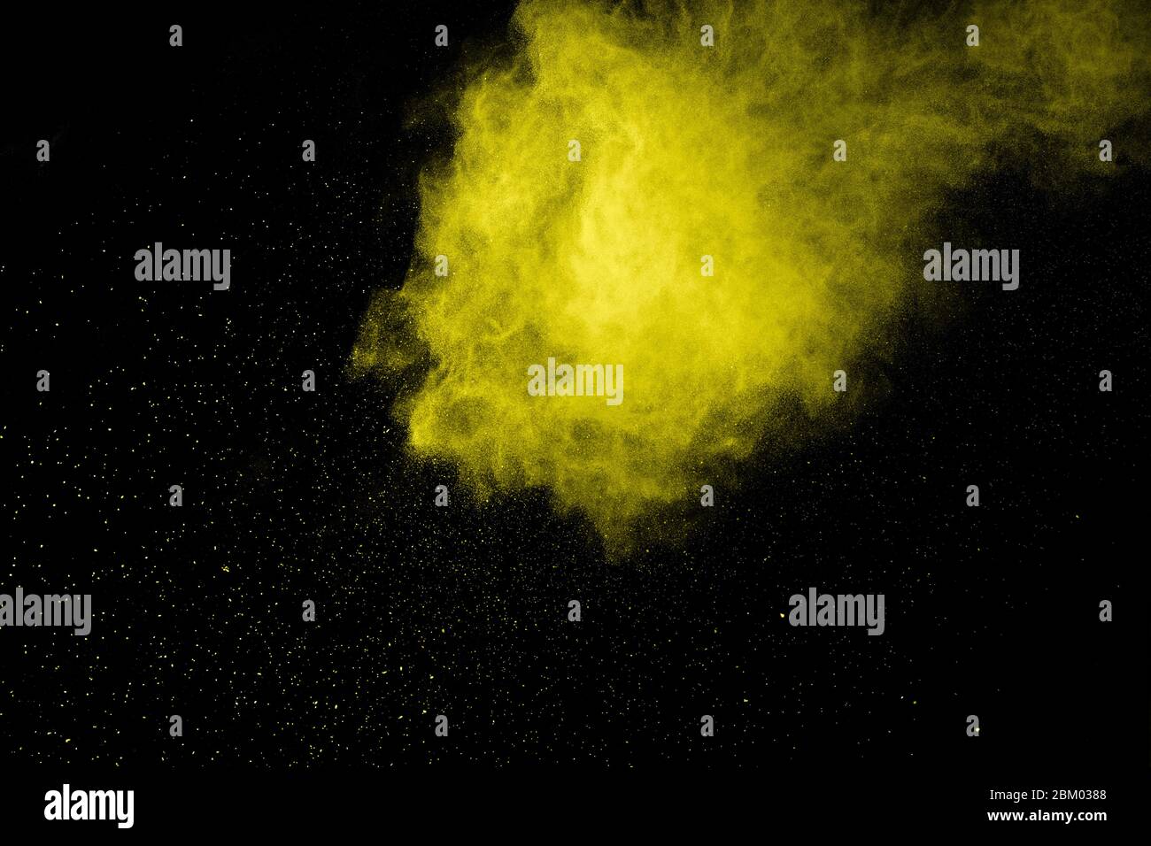 Yellow dust particles explosion on black background.Yellow powder ...