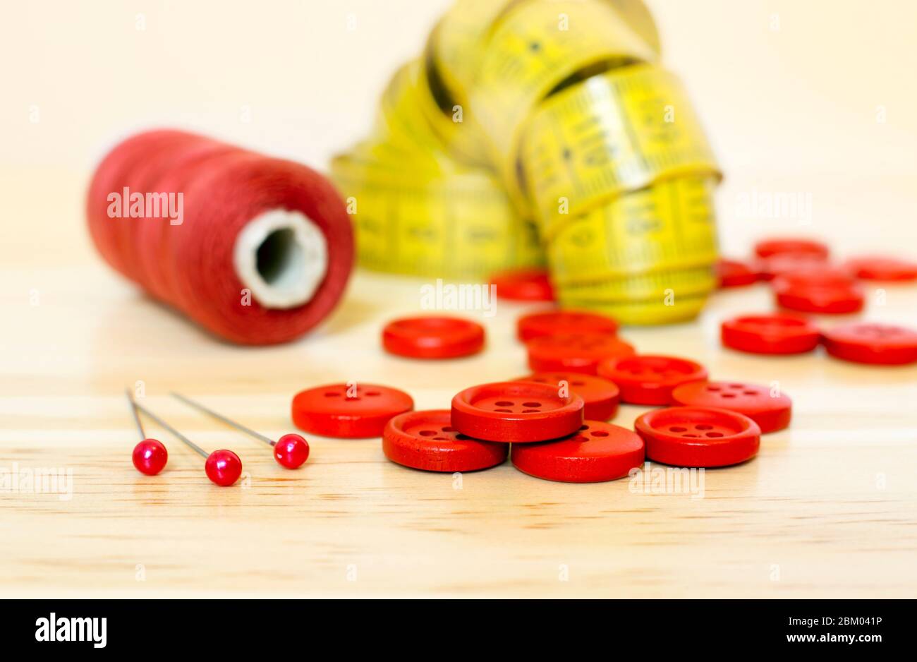DIY concept - red sewing supplies - web banner of pins, buttons, thread ...