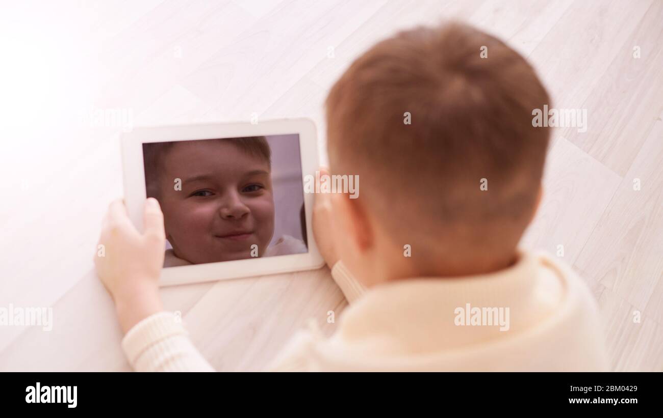 Cute boy. Face on screen. Light background. Horizontal Stock Photo - Alamy