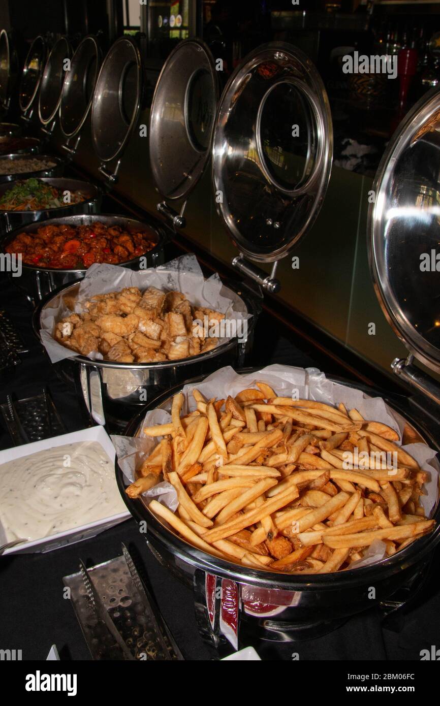 French fries and meat dish on a restaurant metal buffet tray Stock ...