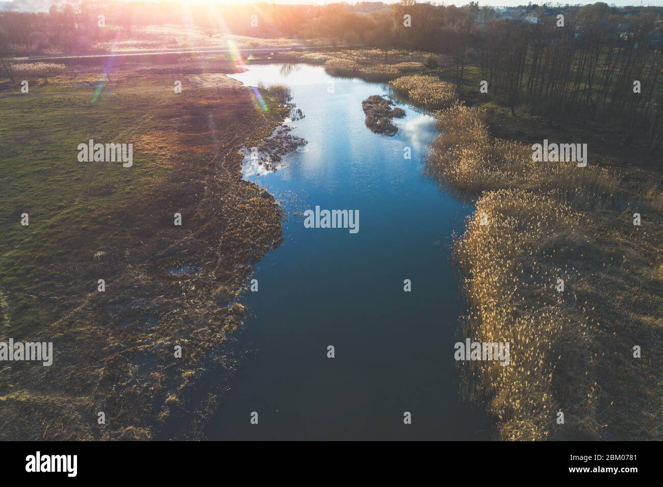 Aerial view of countryside and brook in evening at sunset light ...