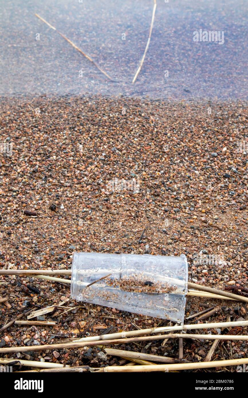 broken clear plastic cup on the beach Stock Photo - Alamy