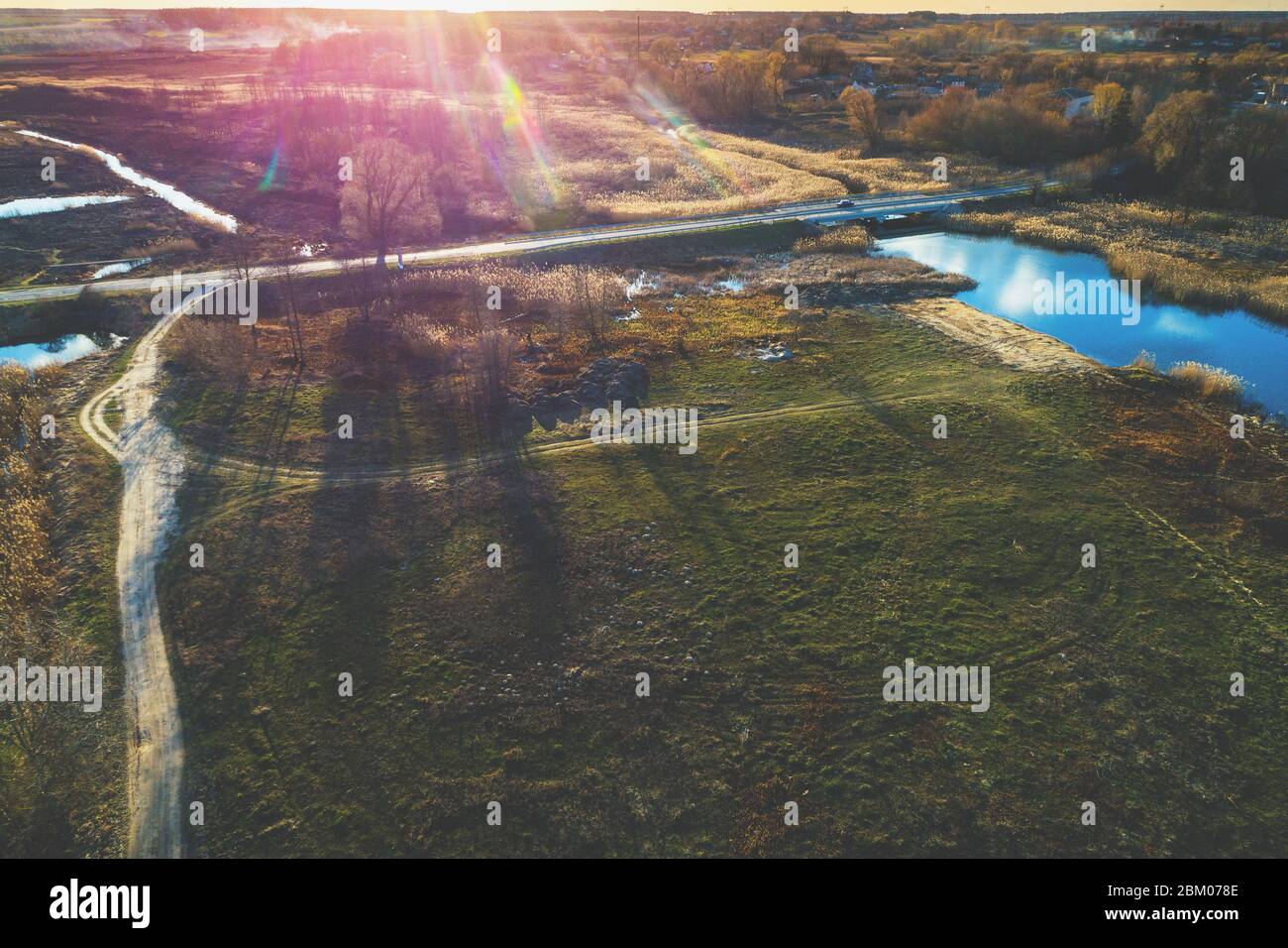 Aerial view of countryside and brook in the evening at sunset light ...