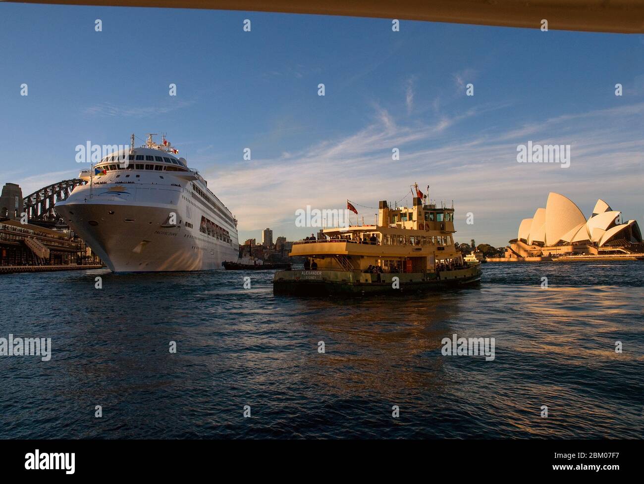 Sydney Opera house and harbour bridge with large cruise ship departing ...