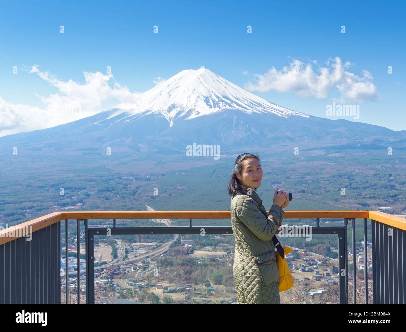 A woman standing on a view point looking at Mount Fuji in Japan Stock ...