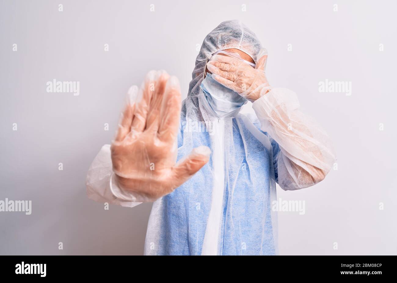 Middle age nurse woman wearing protection coronavirus equipment over ...