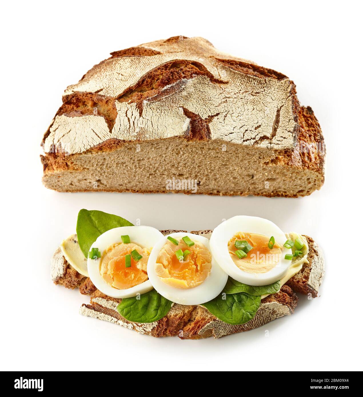 slice of bread with boiled egg and spinach isolated on white background ...