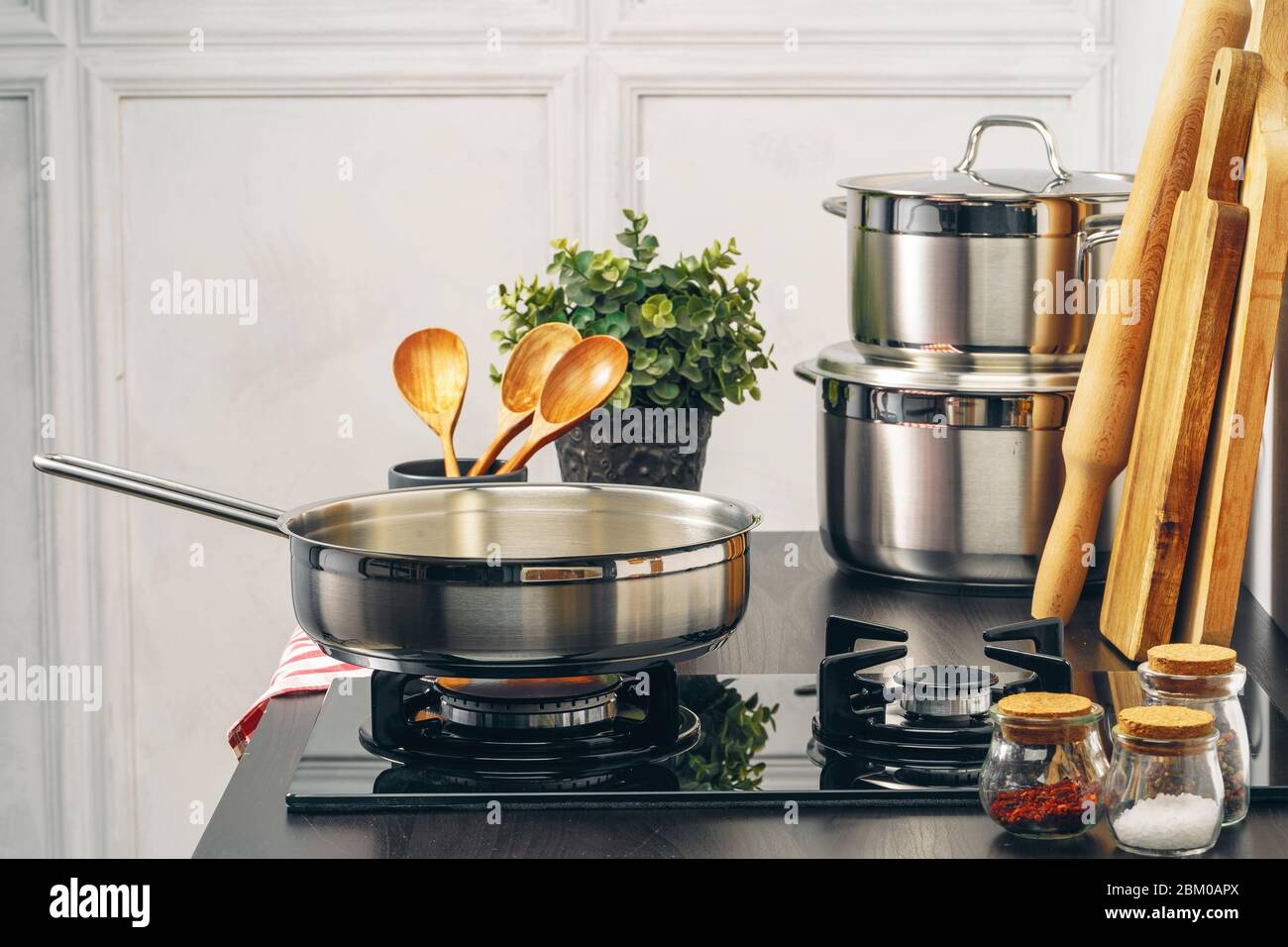 Frying pan on the gas stove in a kitchen Stock Photo - Alamy