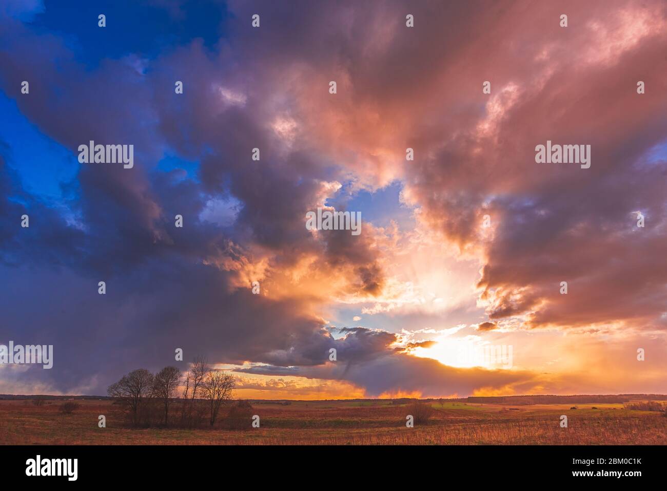 Colorful sunset over farm fields in Lithuania Stock Photo - Alamy