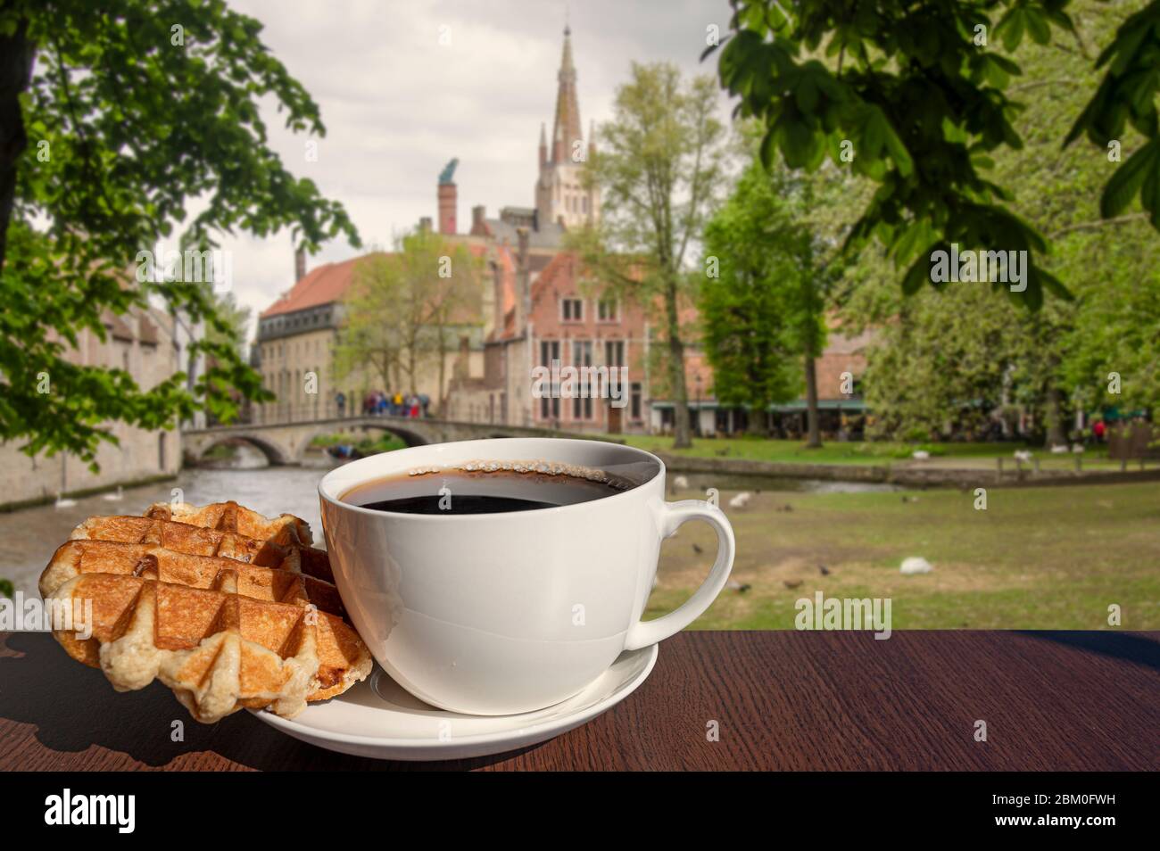 Coffee with Belgian waffle with view on park, canal and historic ...