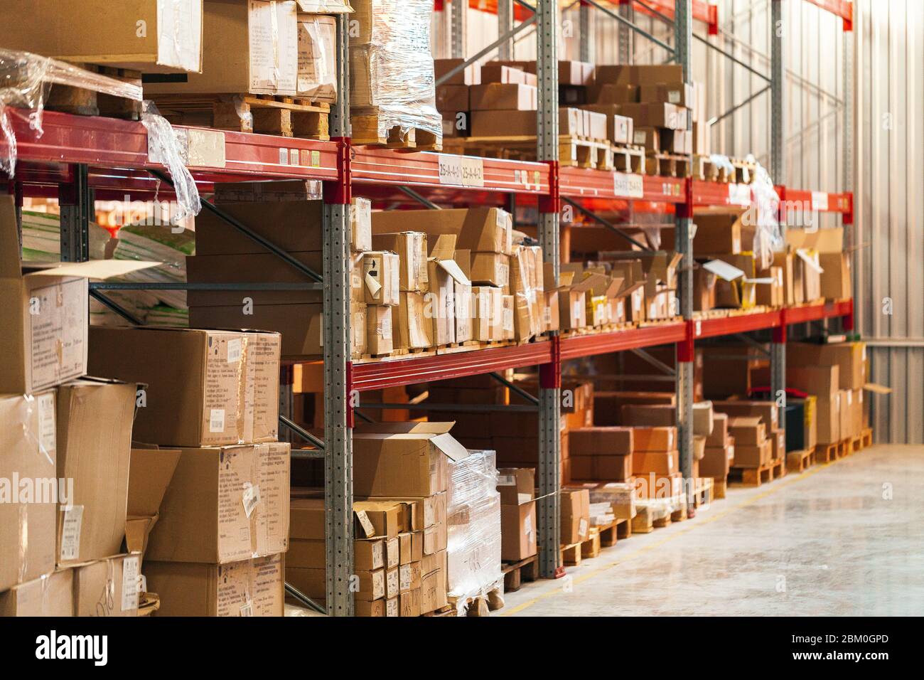 Modern warehouse shelves with pile of cardboard boxes Stock Photo - Alamy