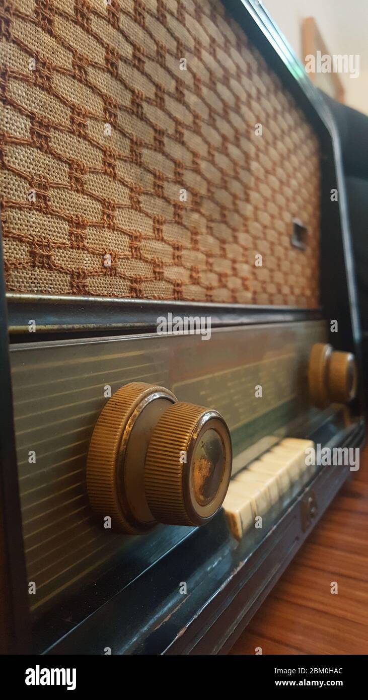 Close up view of a very old radio's front panel with large buttons, in ...